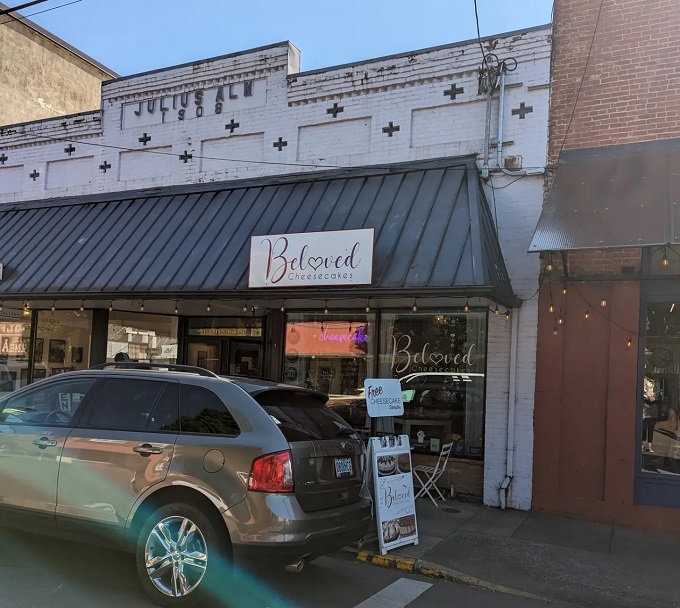 The storefront beckons with its charming simplicity, promising sweet treasures within. That "Free Cheesecake Samples" sign is the culinary equivalent of a siren song.
