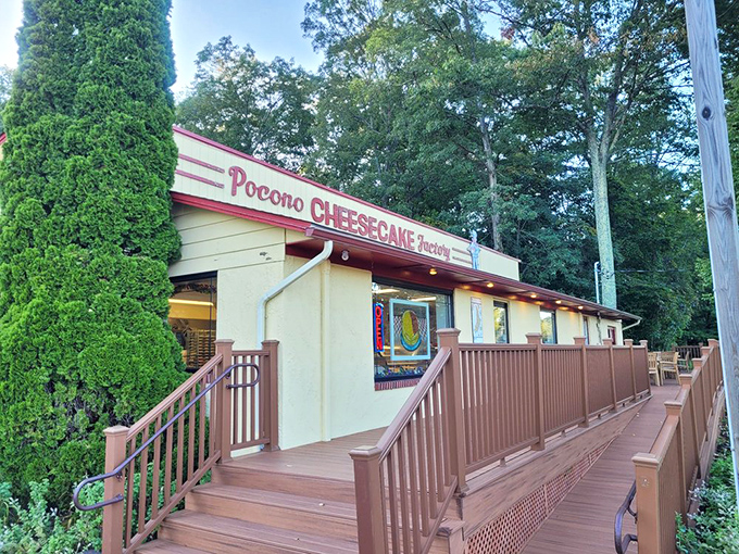 The unassuming exterior of Pocono Cheesecake Factory beckons like a dessert oasis in the woods. Sweet treasures await behind that burgundy sign.
