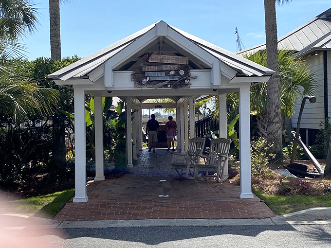 The welcoming pavilion entrance to Skippers Fish Camp beckons like a coastal siren song, promising seafood treasures just beyond those white columns.