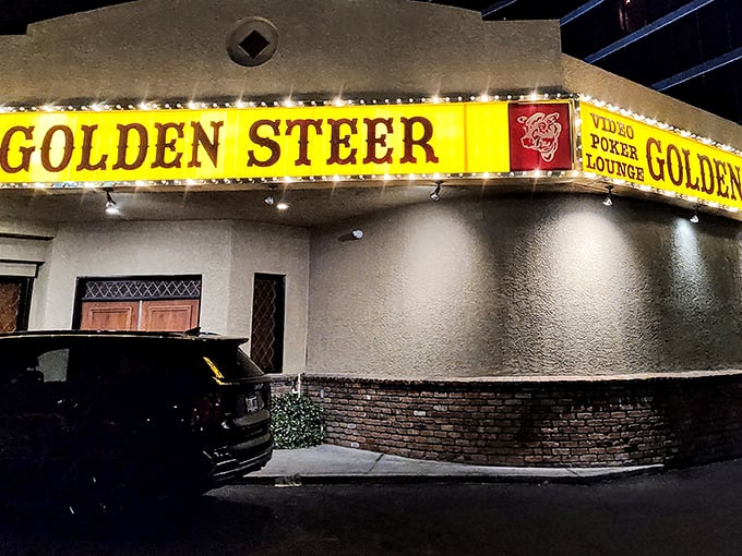 The unassuming exterior of Golden Steer stands like a time capsule amid Vegas glitz, its vintage yellow sign promising authentic experiences inside.
