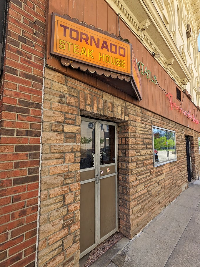 The vintage neon signage beckons hungry Madisonians like a carnivorous lighthouse, promising old-school steakhouse glory within. 