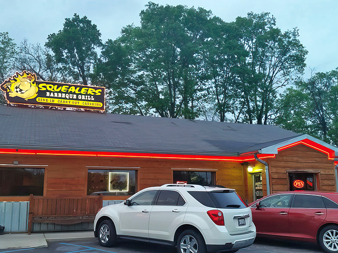 The glowing sign beckons hungry travelers like a smoky lighthouse guiding ships to delicious harbor. BBQ paradise awaits!