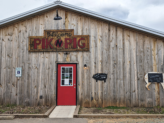 The weathered wooden exterior with that bold red door isn't trying to impress anyone&mdash;and that's precisely why it does. Southern barbecue authenticity at its finest.