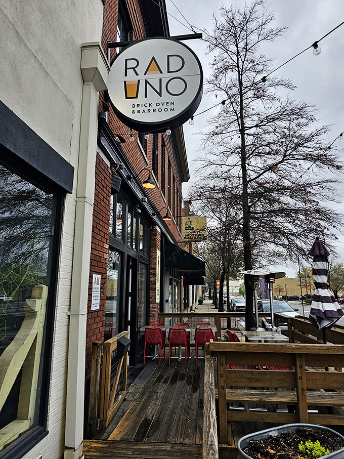 Raduno's circular sign beckons from its brick building home, promising Italian comfort in Little Rock's SoMa district. The wooden patio stands ready for al fresco dining adventures.