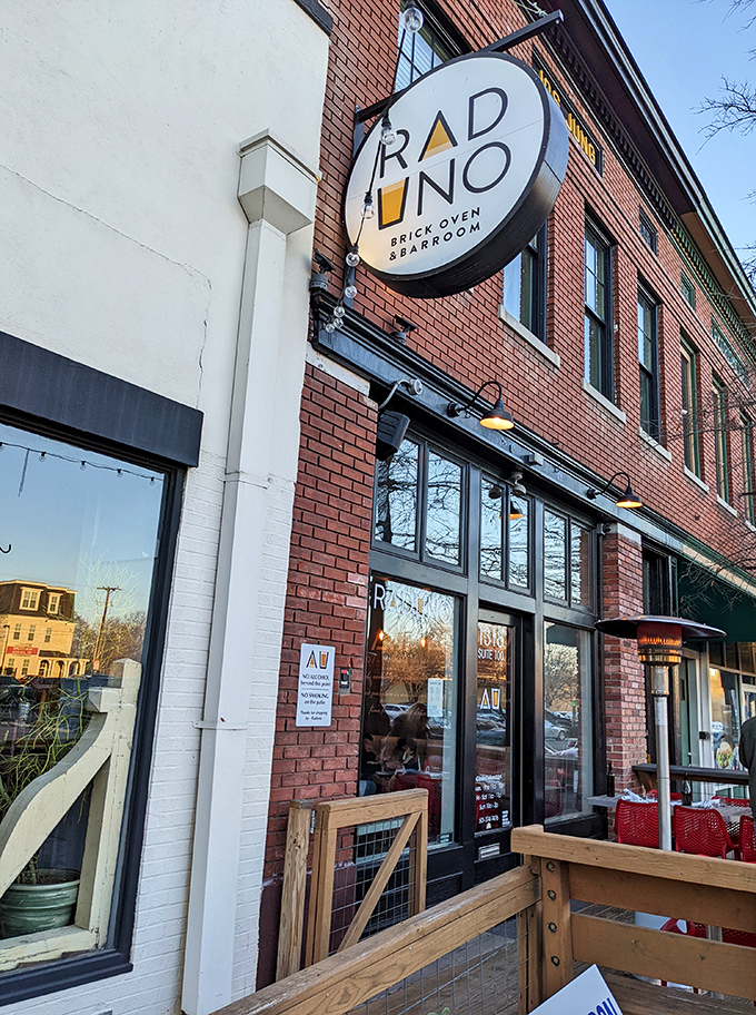 Raduno's circular sign beckons from its brick building home, promising Italian comfort in Little Rock's SoMa district. The wooden patio stands ready for al fresco dining adventures.