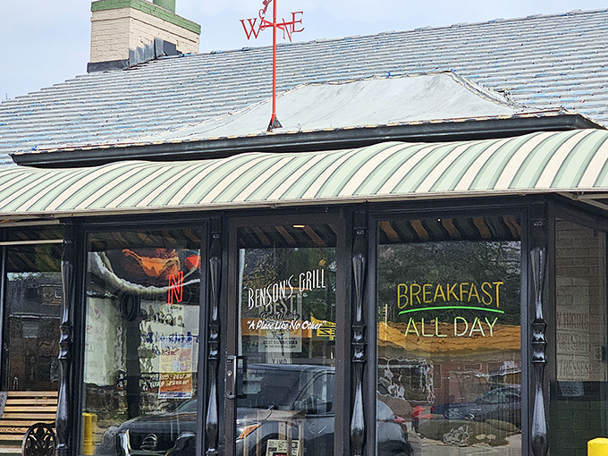 The unassuming exterior of Benson's Grill stands as a beacon to breakfast lovers. That parking sign might as well say "This way to happiness."