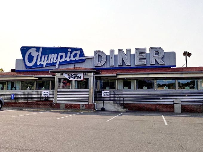 The gleaming stainless steel exterior of Olympia Diner stands as a chrome-plated time capsule on the Berlin Turnpike, beckoning hungry travelers since 1954.