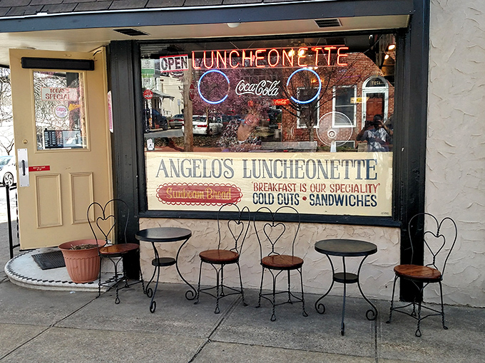 The iconic Pepsi sign beckons hungry travelers to Angelo's Luncheonette, a Wilmington institution where time stands deliciously still since 1967.