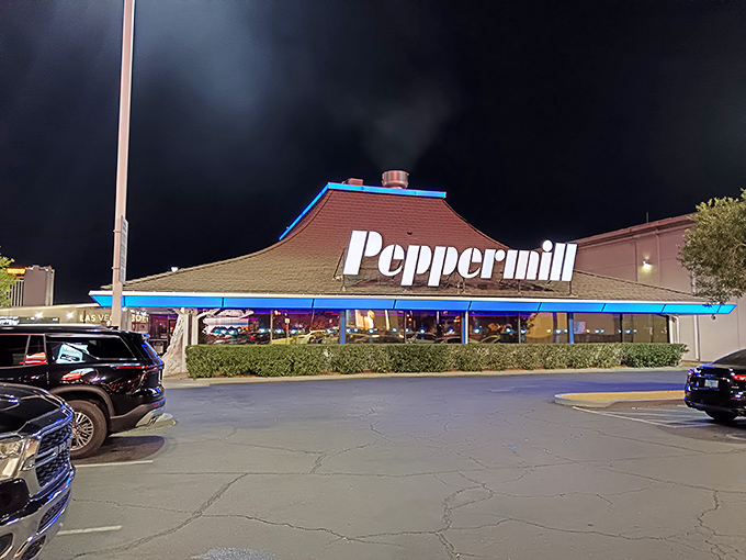 The iconic pagoda-style roof of Peppermill stands like a neon oasis amid the desert of Vegas excess, promising comfort food salvation 24/7.