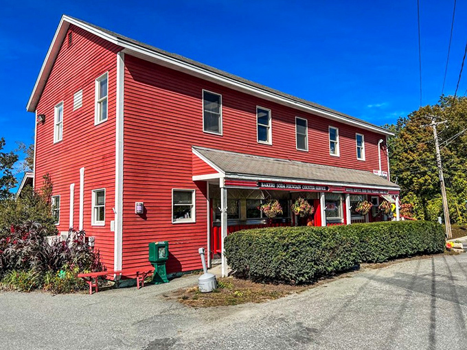 The cherry-red exterior of Four Aces Diner stands out like a winning hand in West Lebanon, beckoning hungry travelers with its classic Americana charm.