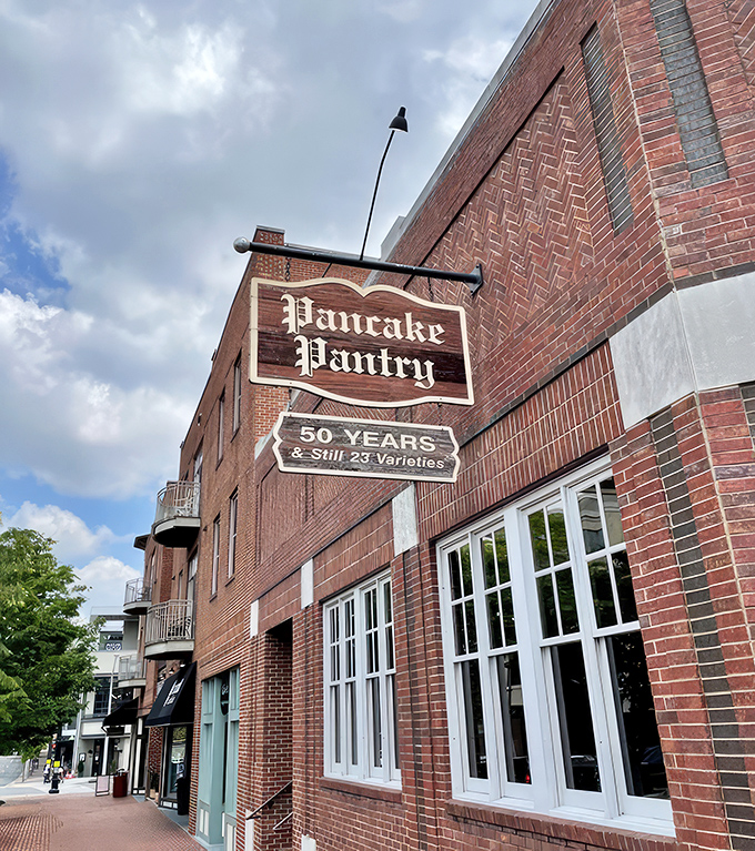 The iconic brick exterior of Pancake Pantry proudly displays its "50 Years & Still 23 Varieties" sign, a testament to perfecting rather than changing a good thing.