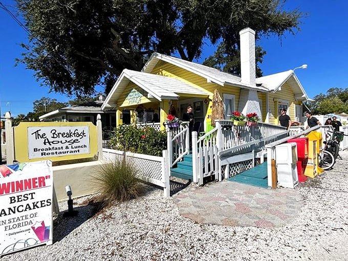 The cheerful yellow cottage with its white picket fence isn't just Instagram-worthy—it's a beacon of breakfast hope in Sarasota's Gillespie Park neighborhood.
