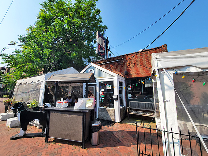 The unassuming brick exterior of Millie's Diner belies the culinary magic happening inside. That colorful mural isn't just decoration—it's a preview of the vibrant flavors awaiting you.