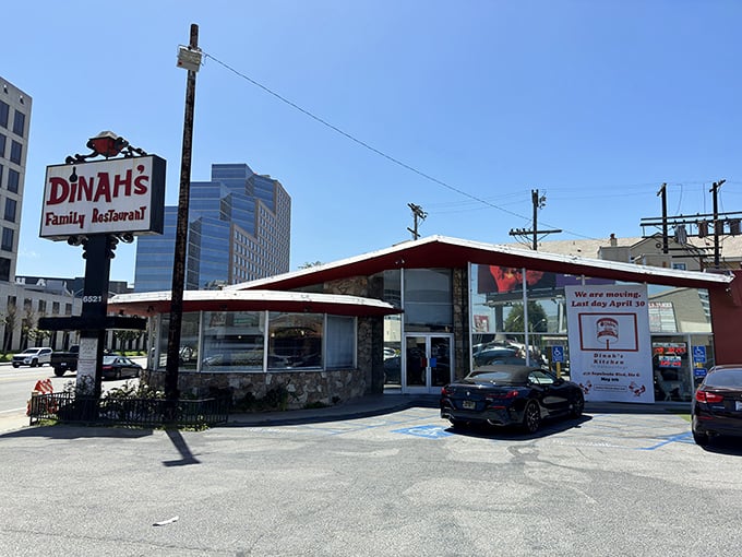 The iconic A-frame and vintage sign of Dinah's stand proud against the LA skyline, a time capsule of mid-century dining glory.