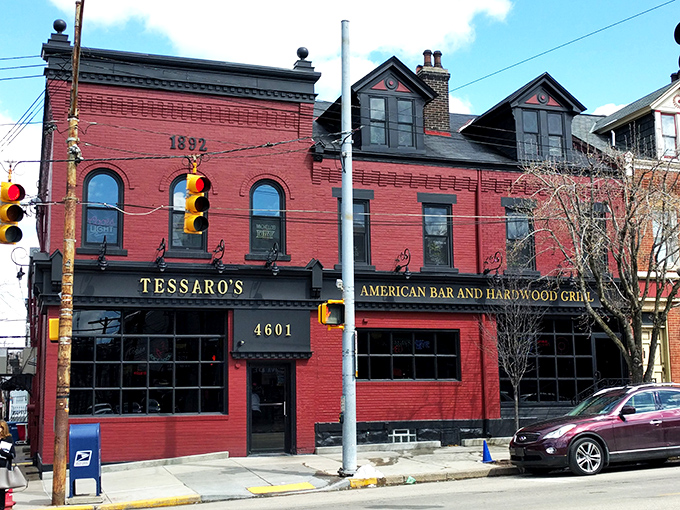 The brick facade of Tessaro's glows like a beacon for burger lovers, its neon signs promising cold beer and hot grills inside.
