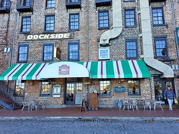 The iconic green and white striped awnings of River House welcome you to a slice of Savannah history on the cobblestone riverfront.