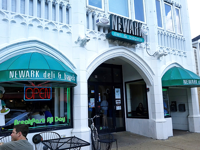 The distinctive white facade with emerald green awnings of Newark Deli & Bagels stands out like a culinary beacon on Main Street.