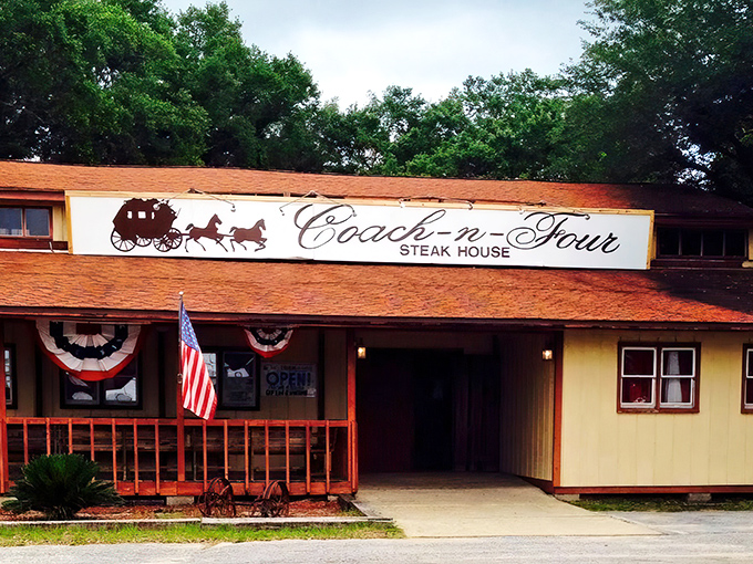 The unassuming exterior of Coach-n-Four Steakhouse stands as a time capsule of old Florida dining, where steak legends are born beneath towering pines.