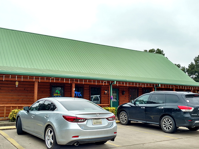 The log cabin exterior of Oaks Steak House welcomes hungry travelers with its distinctive green roof and rustic charm. Oklahoma hospitality in architectural form.