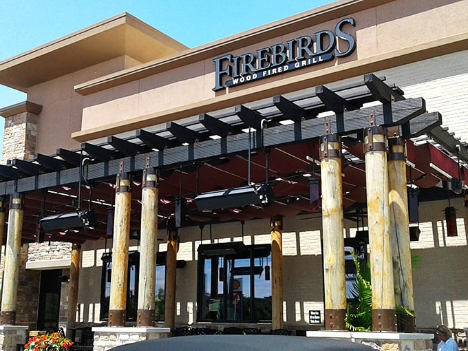 Modern meets rustic at Firebirds' exterior, where stone pillars and contemporary architecture promise a dining experience beyond the ordinary.