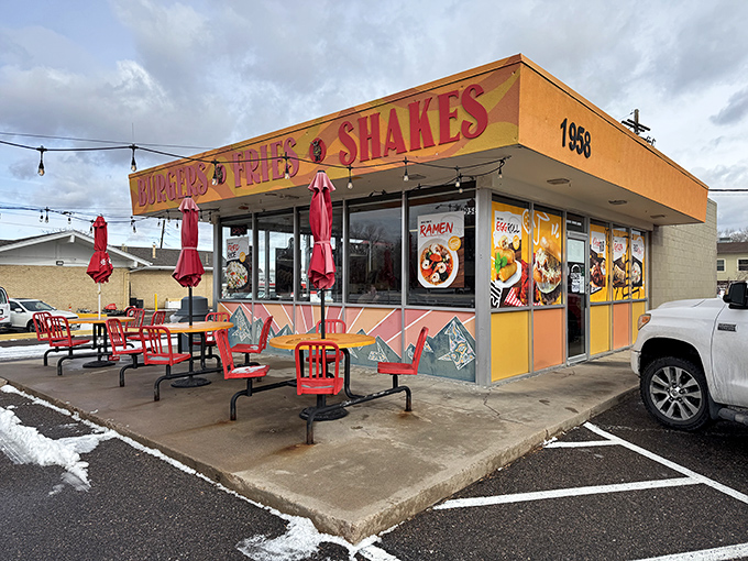 The sunshine-yellow exterior of Big Sky Burger stands out like a beacon for hungry travelers, promising simple pleasures with its no-nonsense "BURGERS &bull; FRIES &bull; SHAKES" declaration.
