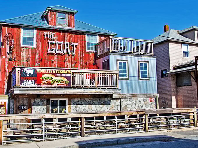 The weathered wooden exterior of The Goat stands proudly against Hampton's skyline, like a delicious pirate ship that decided to drop anchor and serve burgers instead.