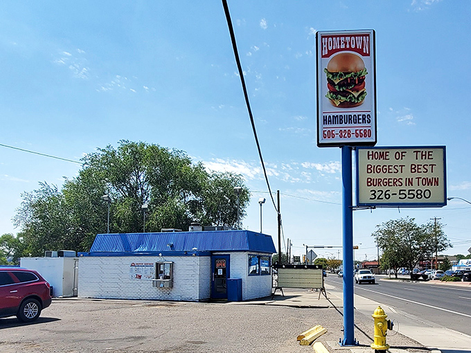 The blue-roofed burger sanctuary beckons with its no-nonsense promise: "Home of the best, seasoned burgers in town." No argument here.