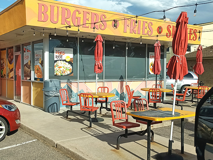 The sunshine-yellow exterior of Big Sky Burger stands out like a beacon for hungry travelers, promising simple pleasures with its no-nonsense "BURGERS &bull; FRIES &bull; SHAKES" declaration.