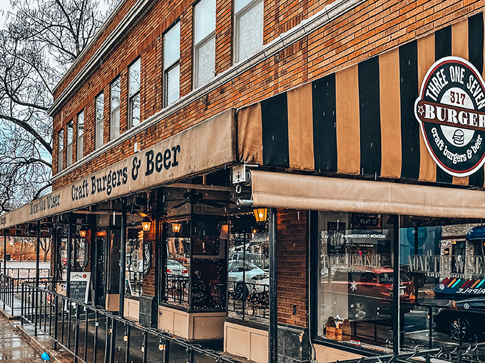 The iconic black and gold striped awning of 317 Burger beckons hungry travelers like a lighthouse for the famished. "Craft Burgers & Beer" isn't just a promise&mdash;it's a mission statement.