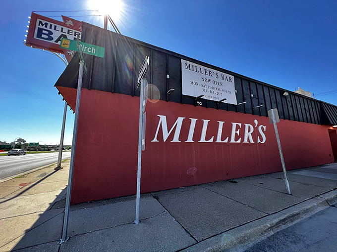 The iconic red sign at Miller's Bar stands like a beacon of burger hope at the corner of Michigan and Birch in Dearborn.