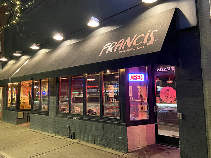 Francis Burger Joint's sleek black exterior beckons hungry passersby with its minimalist charm and promise of burger perfection ahead.