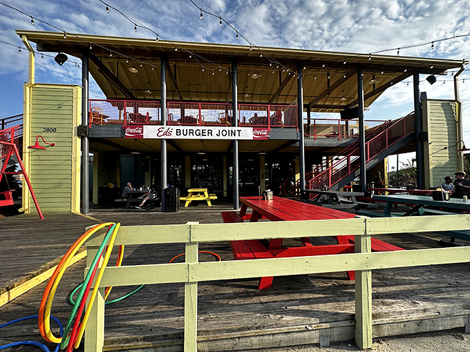 Ed's Burger Joint welcomes you with a playful exterior that promises good times ahead. The red staircase and string lights create an instant vacation vibe. 