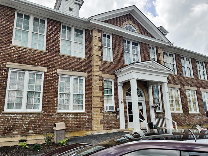 The stately brick exterior of Schoolhouse Fabrics stands as a testament to its educational past, now housing three floors of textile treasures.