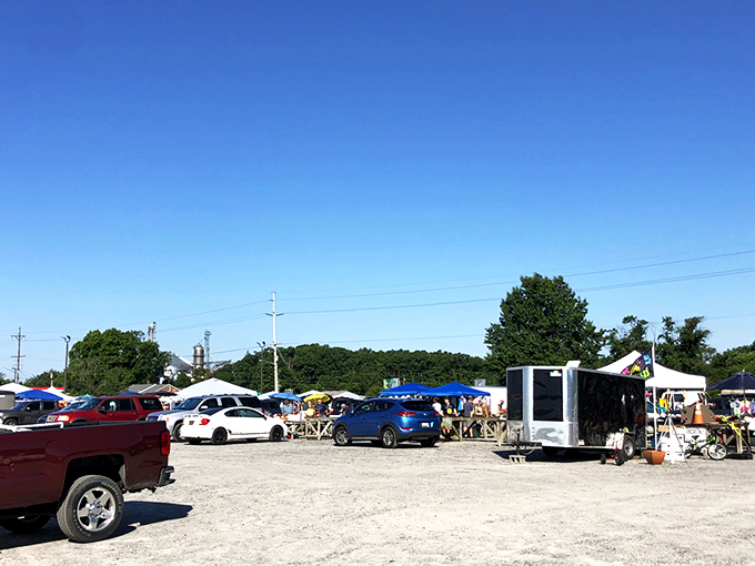 The treasure hunt begins in this unassuming gravel lot, where pickup trucks and sedans gather like prospectors at a modern-day gold rush.
