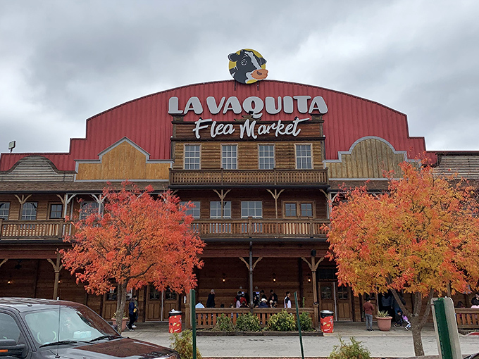 The iconic red-roofed facade of La Vaquita welcomes treasure hunters with its Western-style porch and watchful cartoon cow mascot overhead.