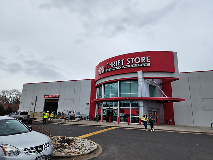 The bold red entrance of Arc Thrift Store beckons like a retail lighthouse, promising treasure hunters the thrill of discovery within its cavernous interior.