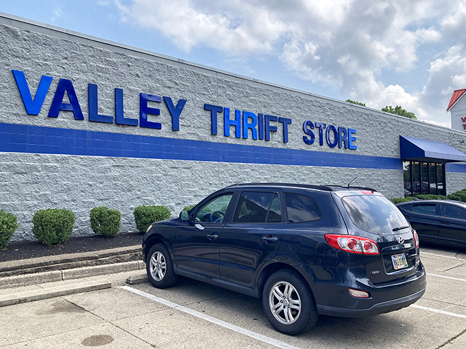 The blue-trimmed exterior of Valley Thrift Store stands like a beacon of bargain possibilities, promising treasure hunts that begin the moment you park your car.