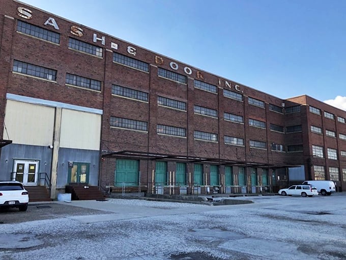 The imposing brick exterior of Midland Arts & Antiques Market still proudly displays its "SASH & DOOR" industrial heritage, promising treasures within those weathered walls.