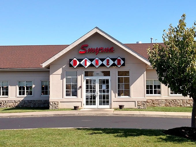 The classic diner silhouette of Smyrna Diner beckons hungry travelers like a lighthouse for comfort food enthusiasts navigating Route 13.