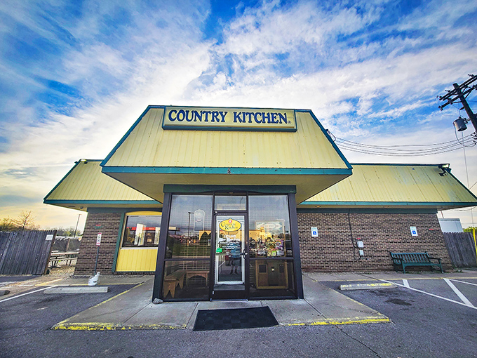 The yellow-trimmed exterior of Country Kitchen stands like a beacon of comfort food promise against the Ohio sky. No fancy architecture, just honest dining ahead.