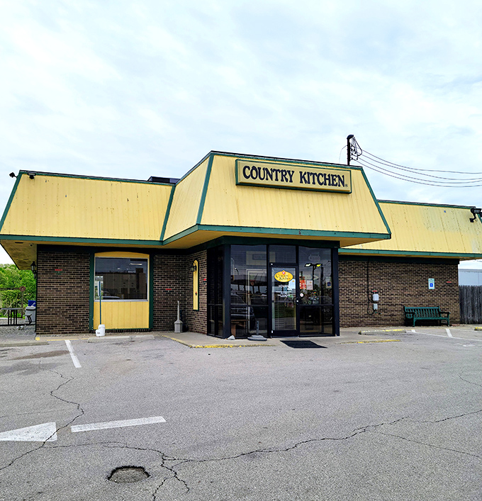 The yellow-trimmed exterior of Country Kitchen stands like a beacon of comfort food promise against the Ohio sky. No fancy architecture, just honest dining ahead.