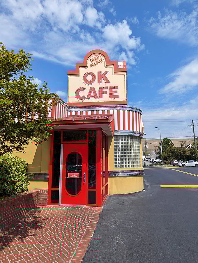 The iconic red and white striped awning of OK Cafe stands like a beacon of comfort food promise against the Atlanta sky.