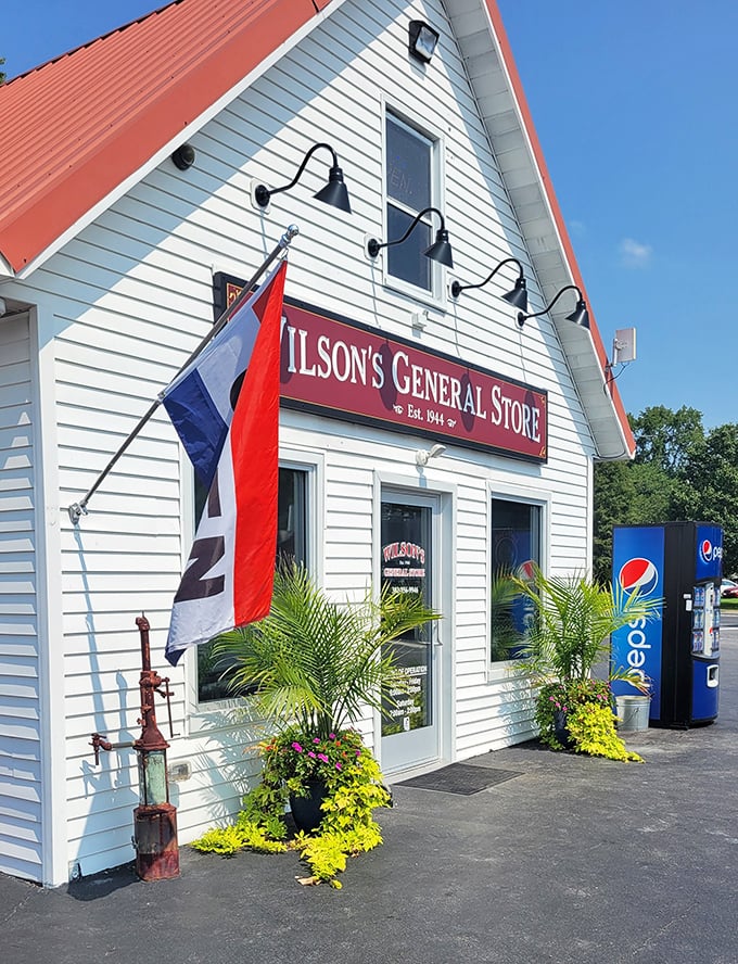 The classic white clapboard exterior of Wilson's General Store stands proudly against a blue Delaware sky, promising culinary treasures within those humble walls.