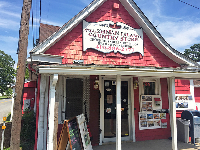 The cherry-red clapboard exterior of Tilghman Island Country Store stands like a beacon of hope for hungry travelers, promising culinary treasures within its humble walls.