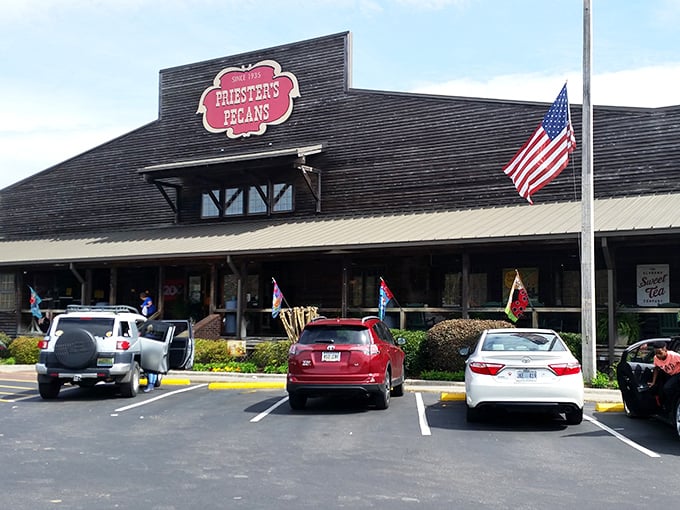 The rustic charm of Priester's Pecans welcomes travelers like a Southern hug, its iconic red sign promising sweet salvation just off I-65.