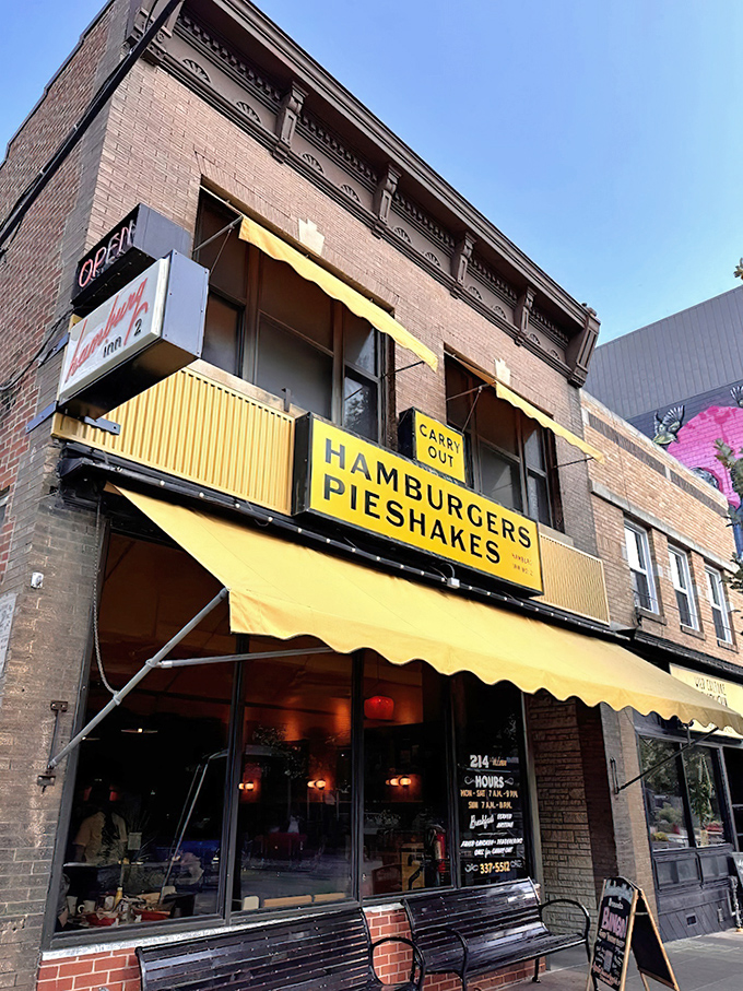 The iconic yellow awning of Hamburg Inn No. 2 beckons like a culinary lighthouse on Linn Street, promising comfort food that's stood the test of time since 1948.