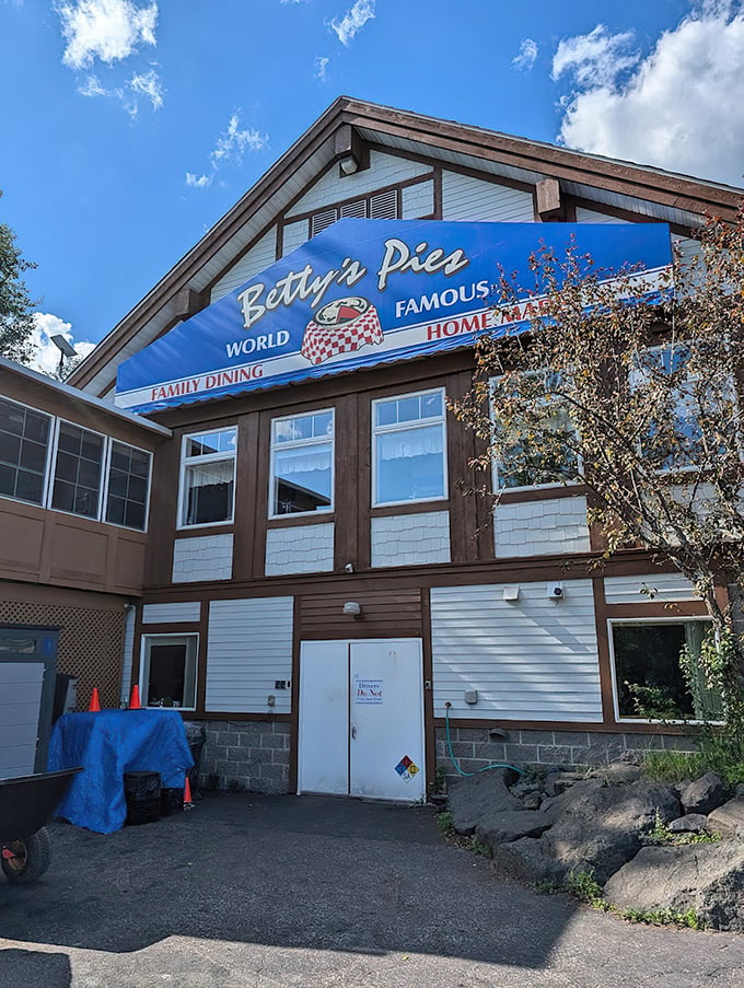 Betty's Pies stands like a North Shore sentinel, its blue sign and American flag promising comfort and sweetness to weary travelers.