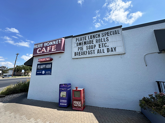 The unassuming exterior of Blue Bonnet Cafe stands like a beacon of hope for hungry travelers. Texas sunshine and pie await.