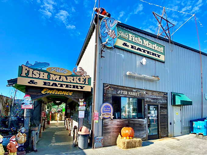 The unassuming exterior of Phil's Fish Market stands beneath Castroville's iconic sign, proving that culinary treasures often hide in plain sight.