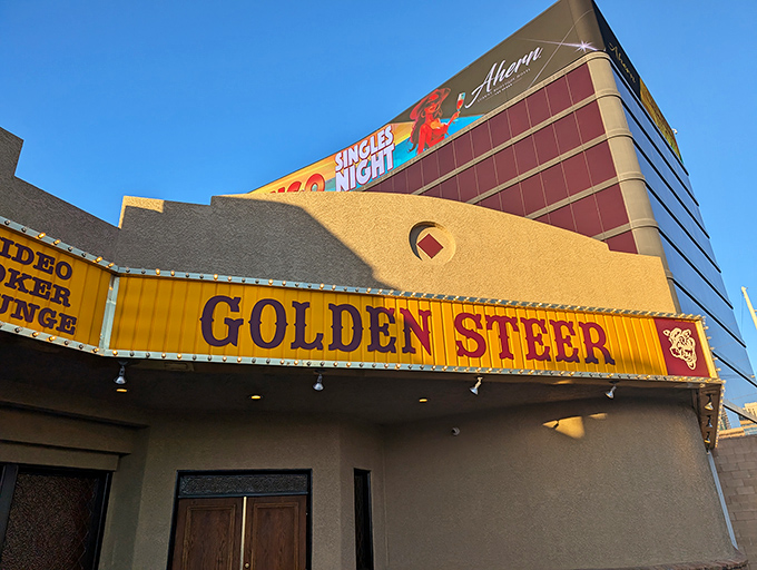 The unassuming exterior of Golden Steer stands like a time capsule amid Vegas glitz, its vintage yellow sign promising authentic experiences inside.